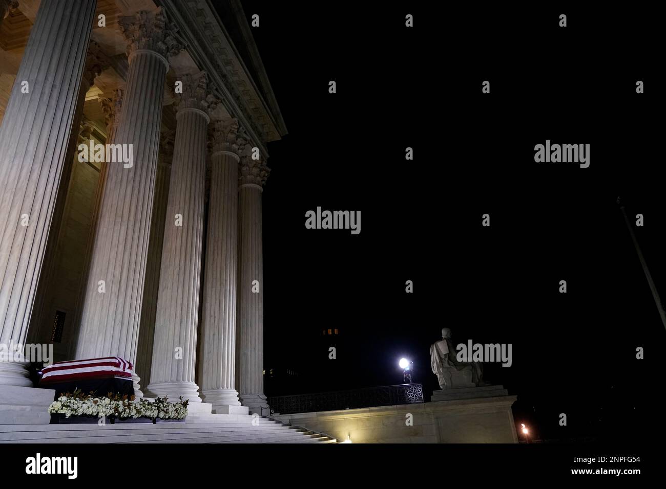 Lights shine on the flag-draped casket of Justice Ruth Bader Ginsburg ...