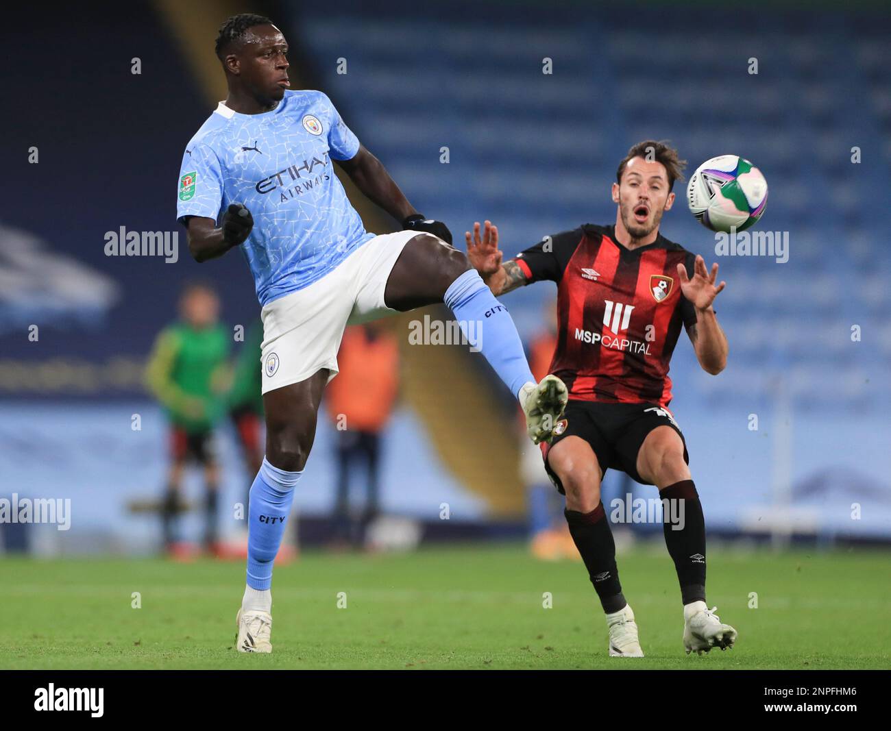 Manchester City's Benjamin Mendy, left, kicks the ball clear of Bournemouth's Adam Smith, right ...