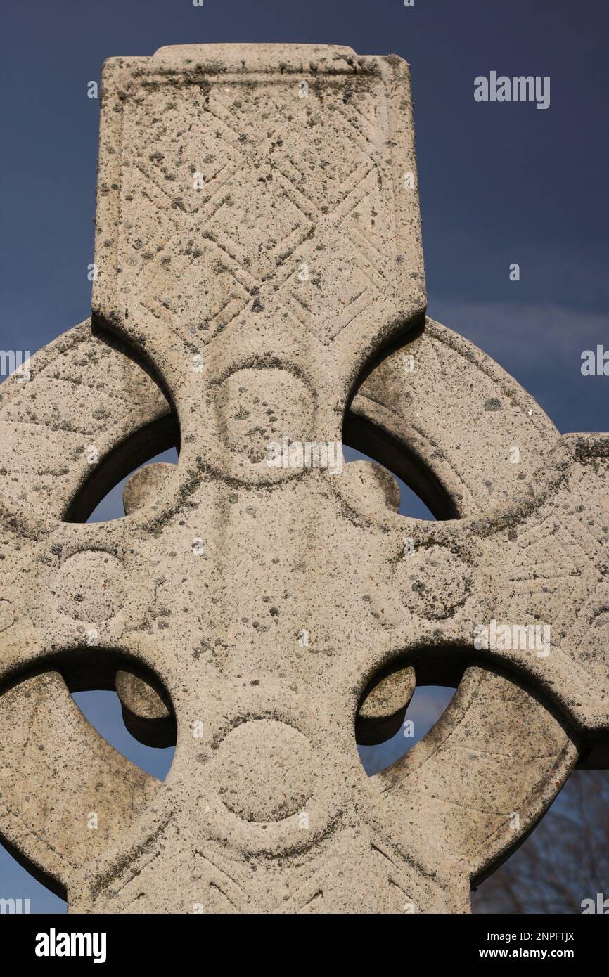 Old Celtic cross standing in the meadow carved out of natural stone ...