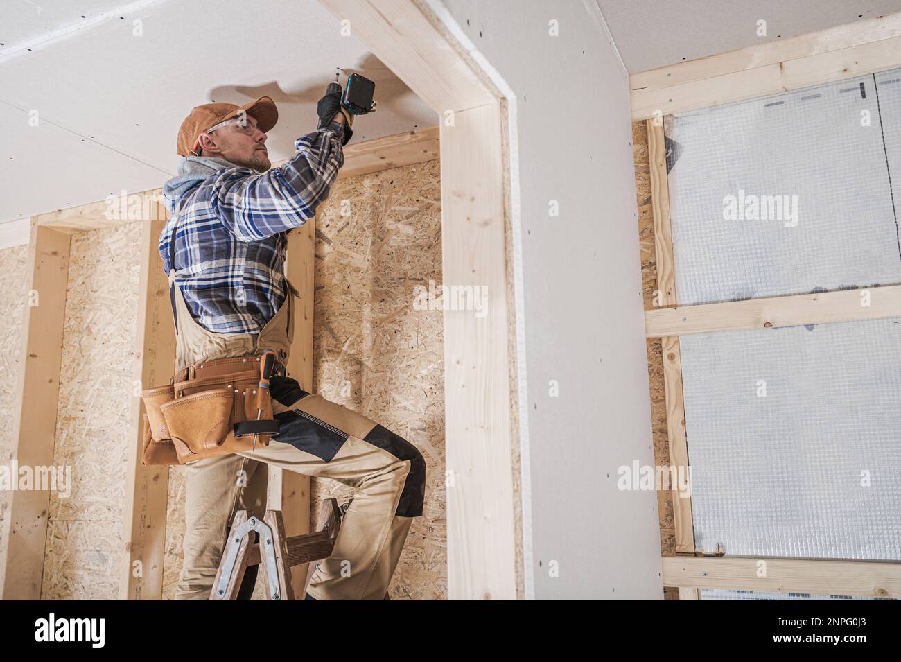 General Construction Contractor Attaching Drywall Using Cordless Drill ...