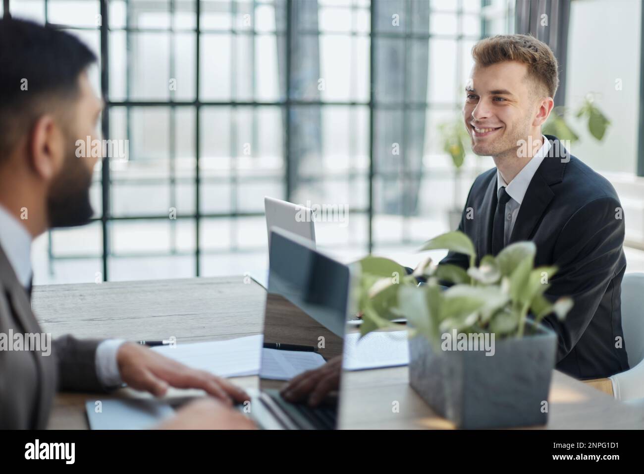 Two happy men working together on a new business project Stock Photo ...