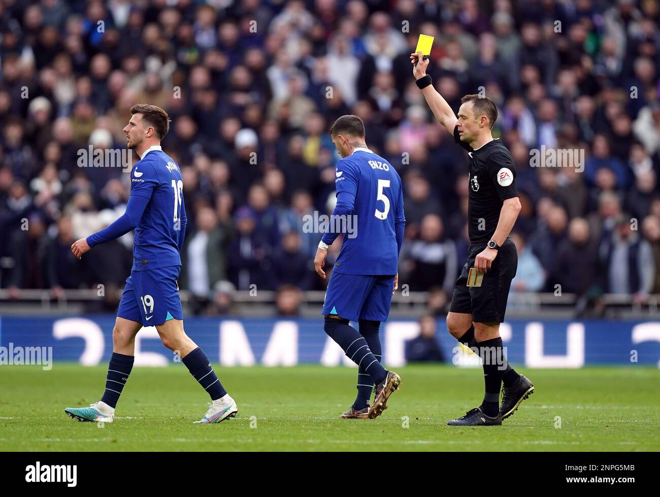 Referee Stuart Attwell shows a yellow card to Chelsea’s Mason Mount ...