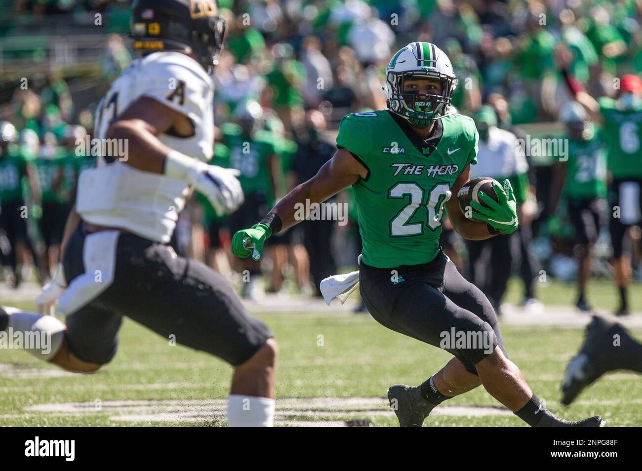 Marshall running back Brenden Knox, right, attempts to juke past ...