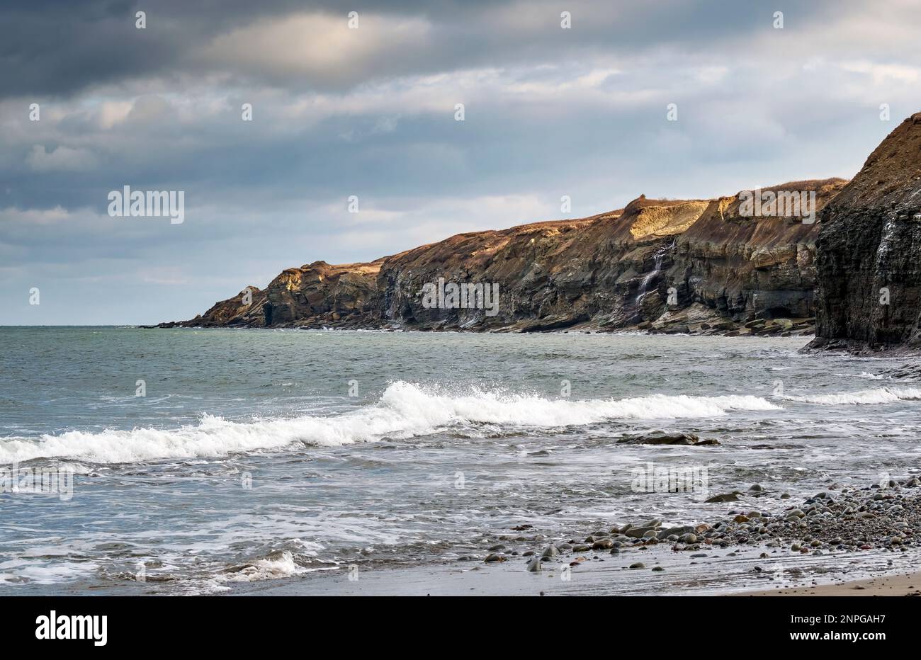 Late afternoon sun kisses the cliffs along the rugged, Atlantic coast ...