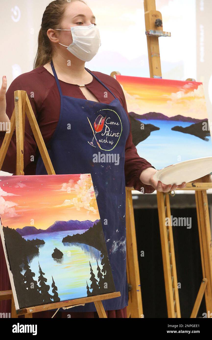 Come Paint With Us instructor Katherine Dorland references her finished piece of Lake Tahoe's ...