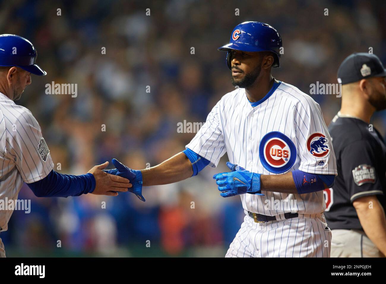 Chicago Cubs Dexter Fowler (24) shakes hands with first base coach ...