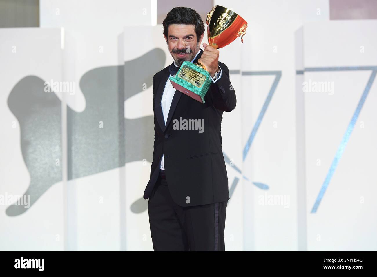 Italian actor Pierfrancesco Favino poses with the Coppa Volpi for Best ...