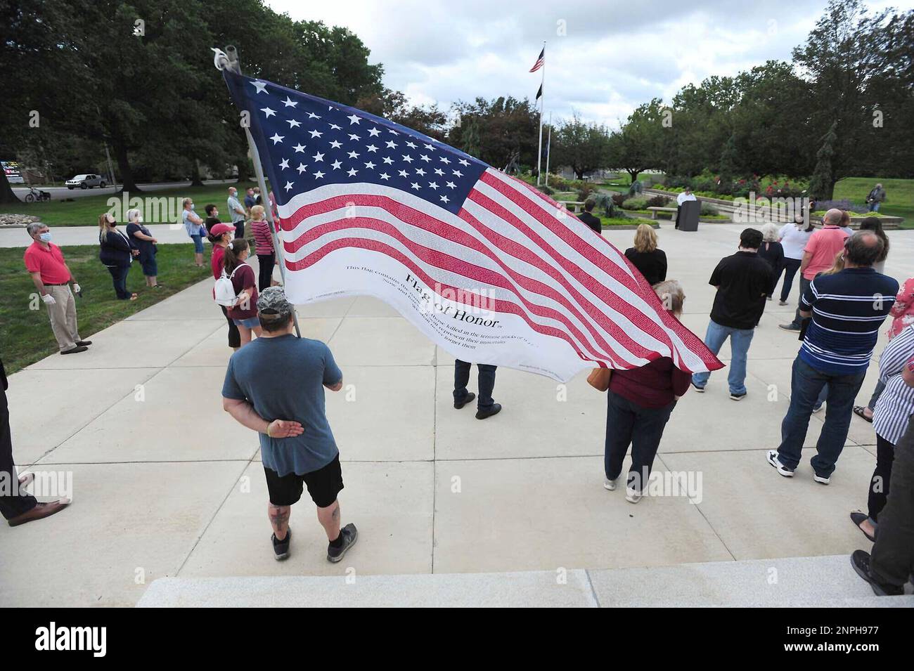 Veteran and Luzerne County employee Dino Ninotti holds a Flag of Honor ...