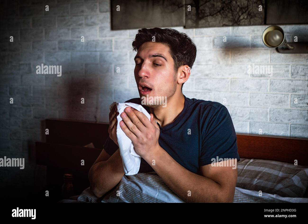Young man about to sneeze, with handkerchief Stock Photo - Alamy