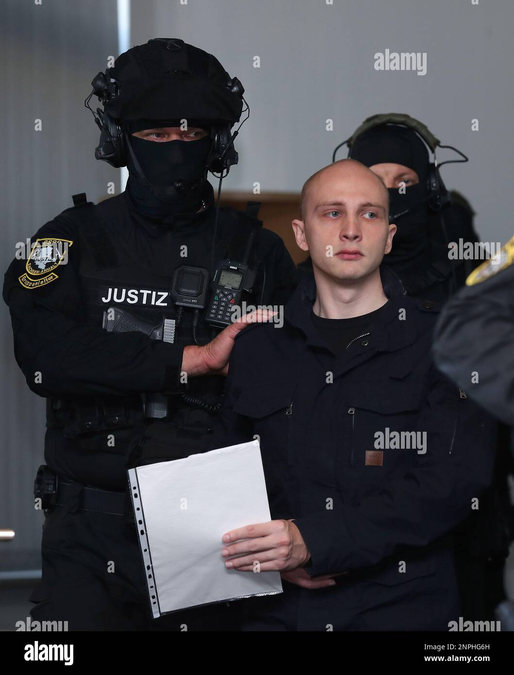 The accused Stephan Balliet is led into the courtroom in handcuffs at ...