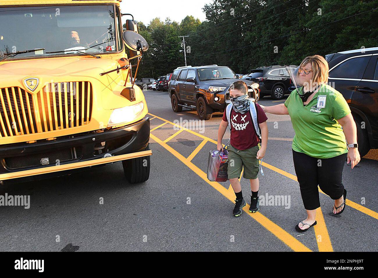 Hollywood Elementary School principal Tamber Hodges, right, walks Wyatt ...