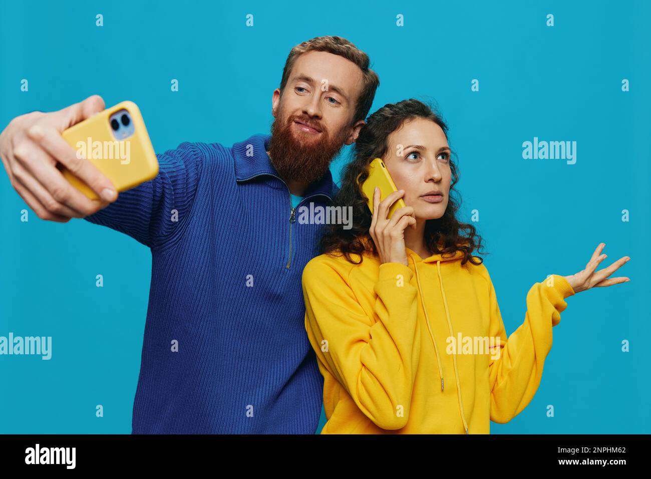 Woman and man funny couple with phones in hand taking selfies crooked ...