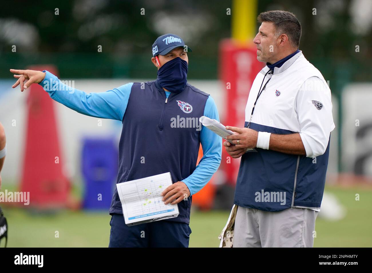 FILE - Tennessee Titans head coach Mike Vrabel, right, talks with ...