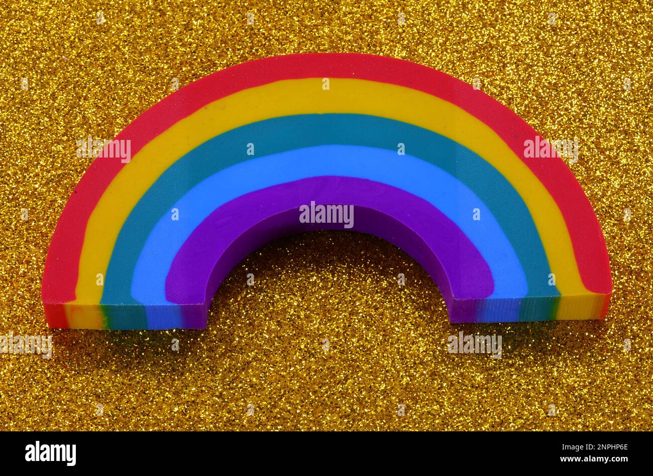 colorful rainbow with bands of five colors and a golden glitter ...