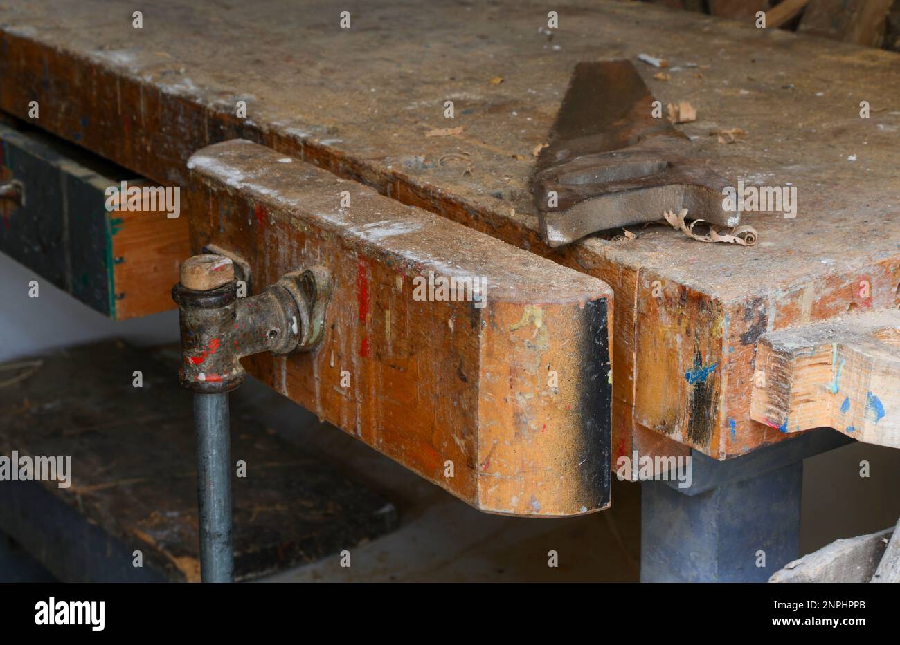 old vise in the workbench of an artisan carpentry and a saw with a ...
