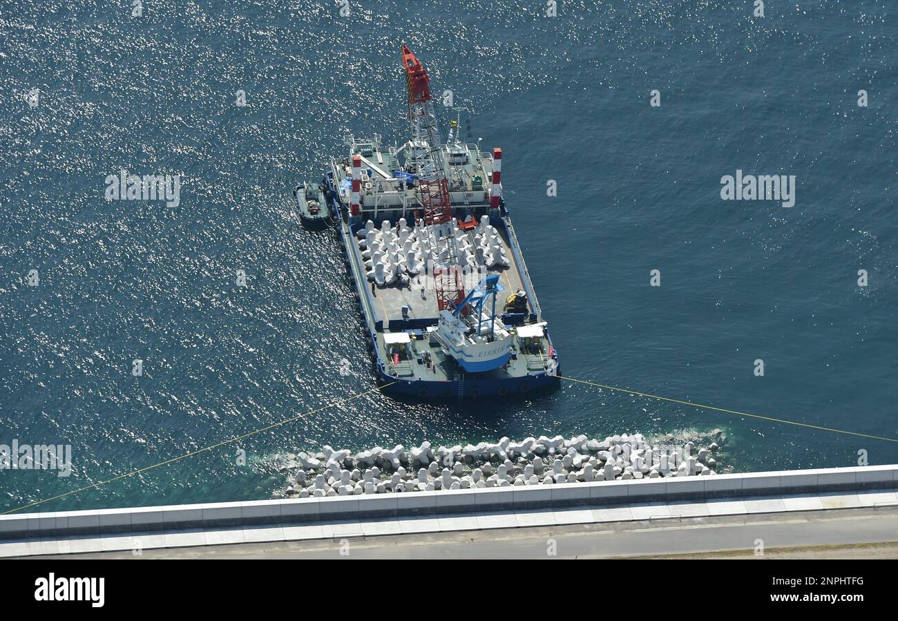 An aerial photo shows the installation work of wave-dissipating block ...