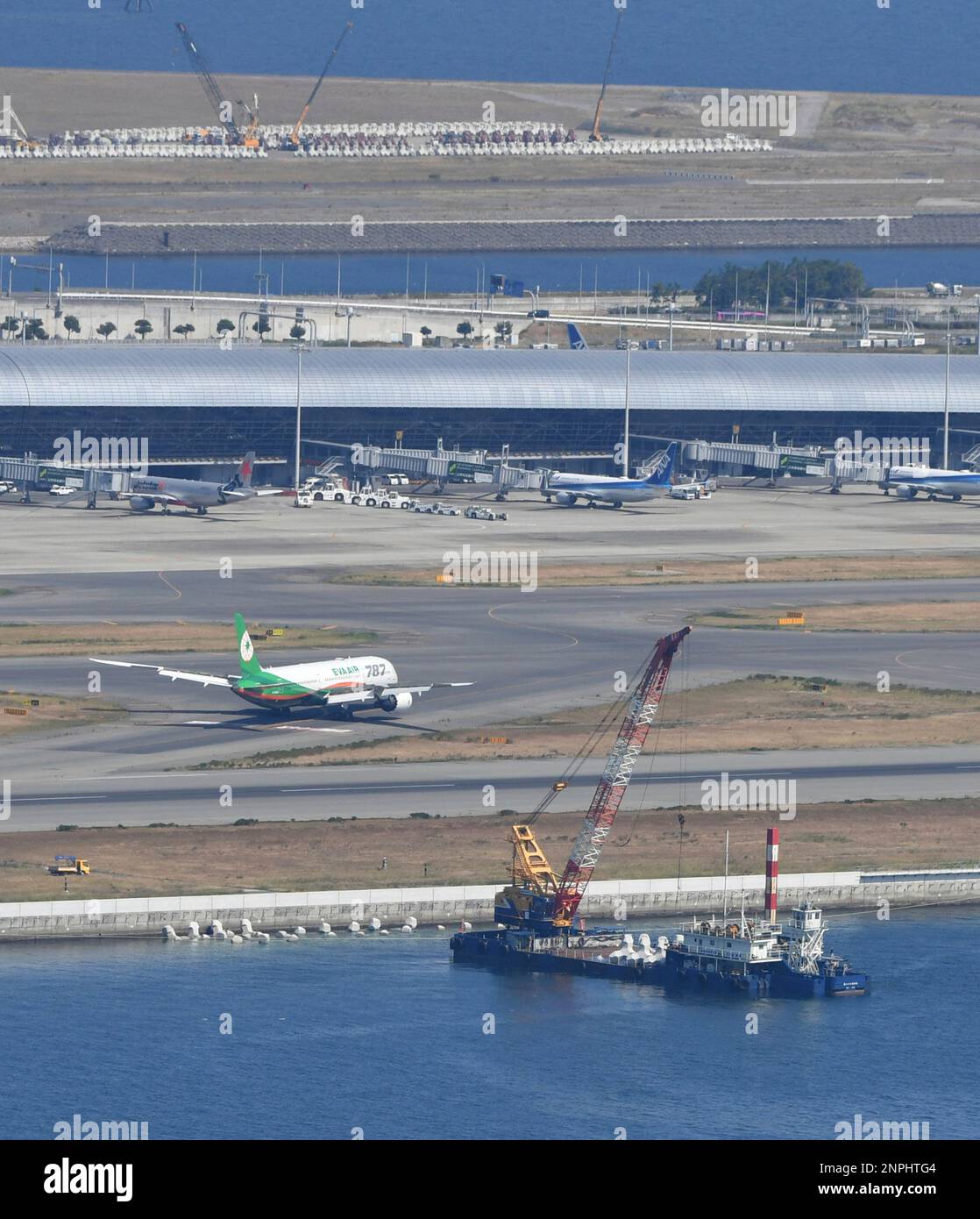 An aerial photo shows the installation work of wave-dissipating block ...