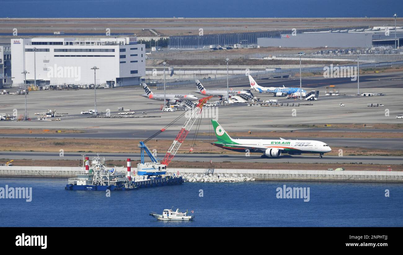 An aerial photo shows the installation work of wave-dissipating block ...