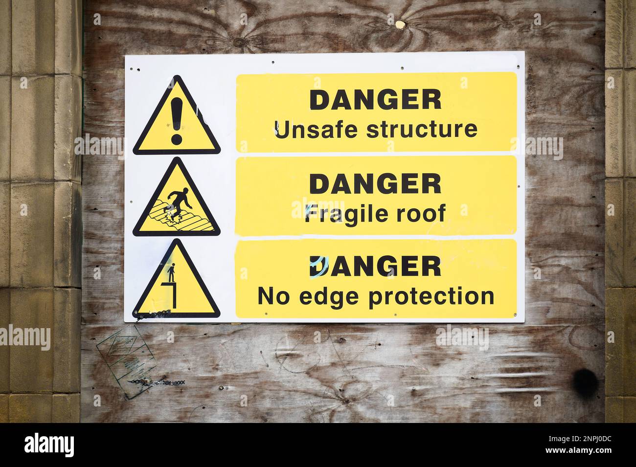 Unstable building keep out dangerous sign on fence at building ...