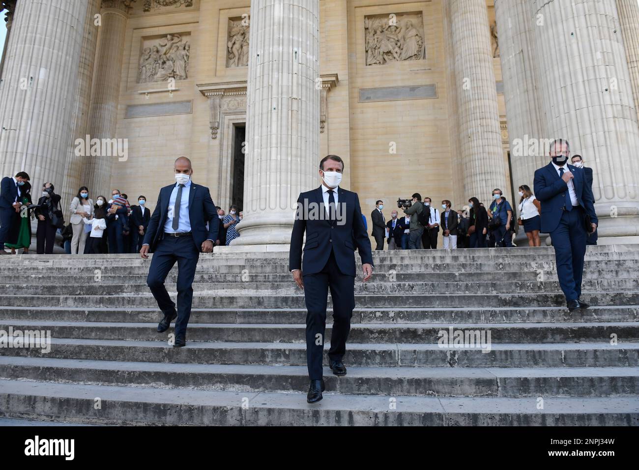 French President Emmanuel Macron, center, leaves after a ceremony to ...