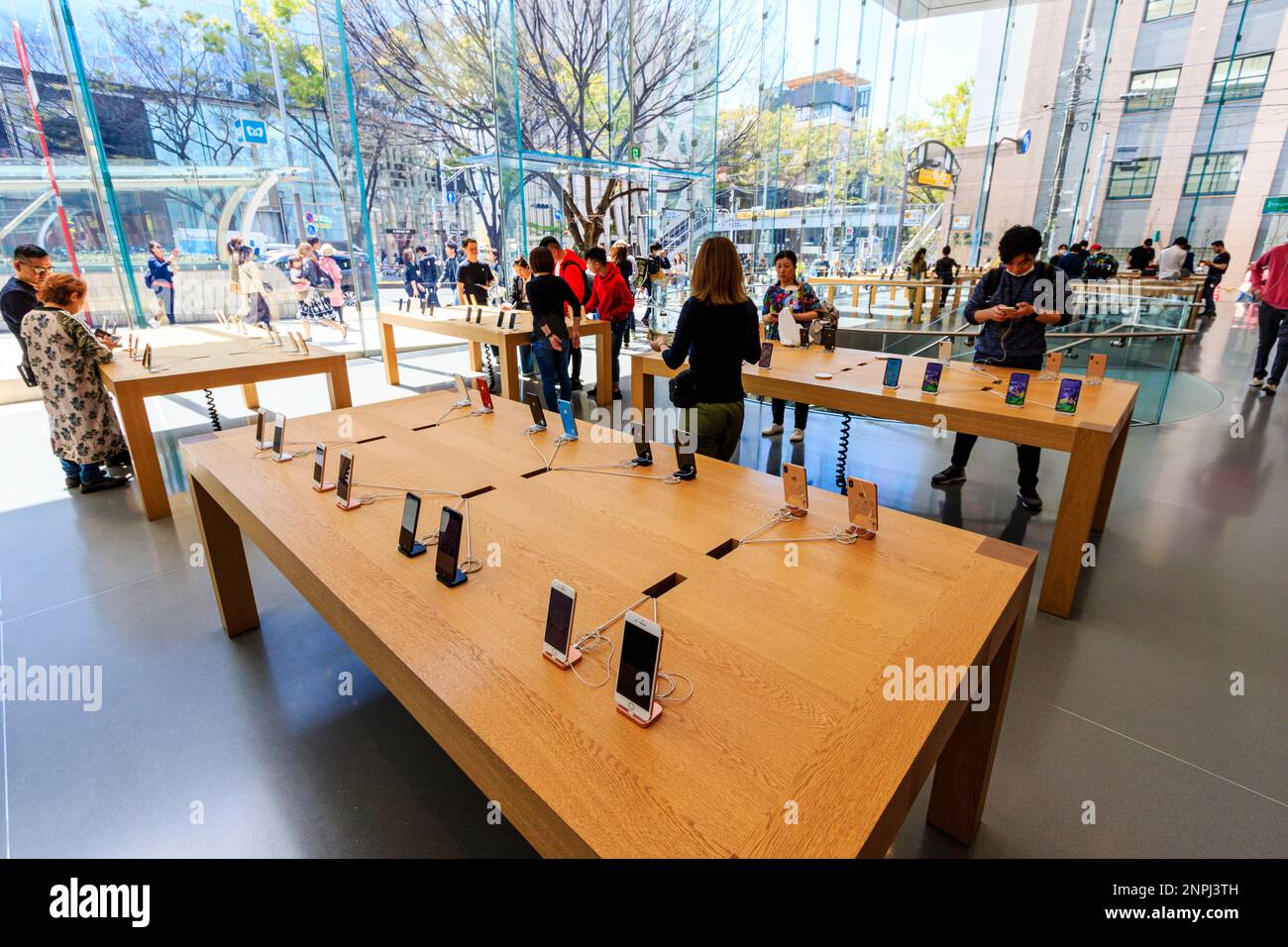 Interior of the Apple store in Omotesando, Tokyo. People looking at the ...