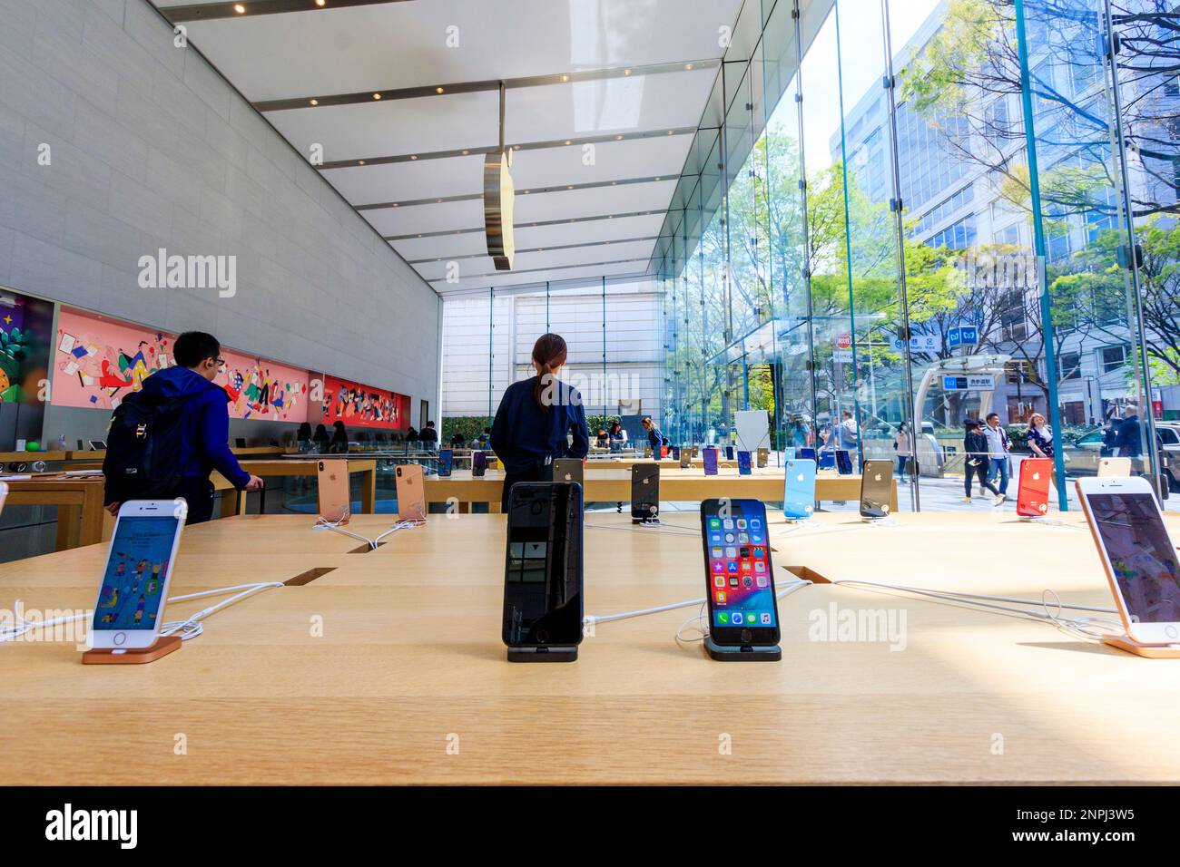 Interior of the Apple store in Omotesando, Tokyo. People looking at the ...