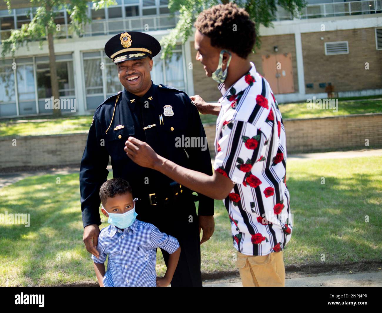 Flint Police Chief Terence Green smiles as his son Justice, 23, helps ...