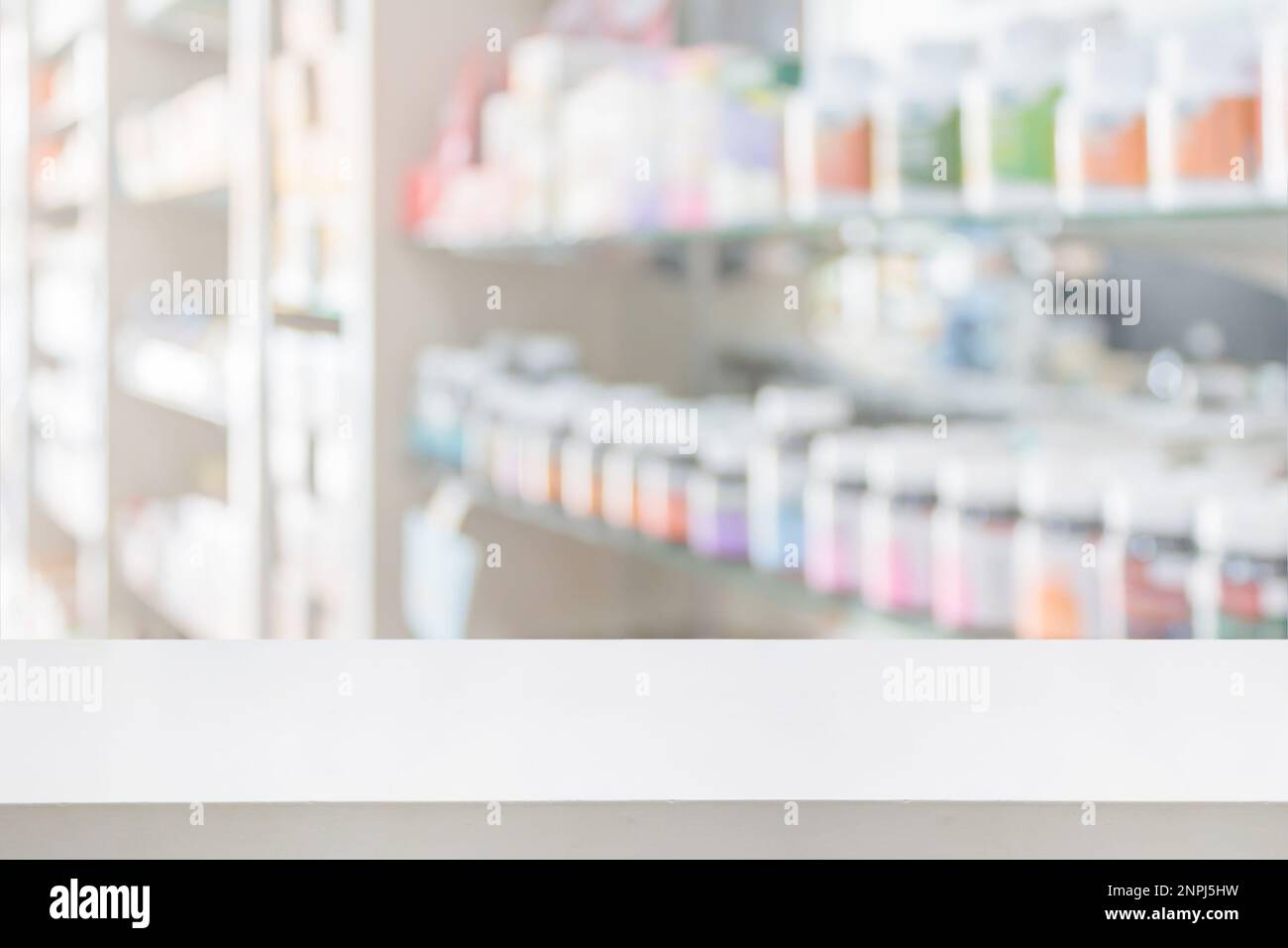 pharmacy store counter table top with blur medicine on shelves in the ...