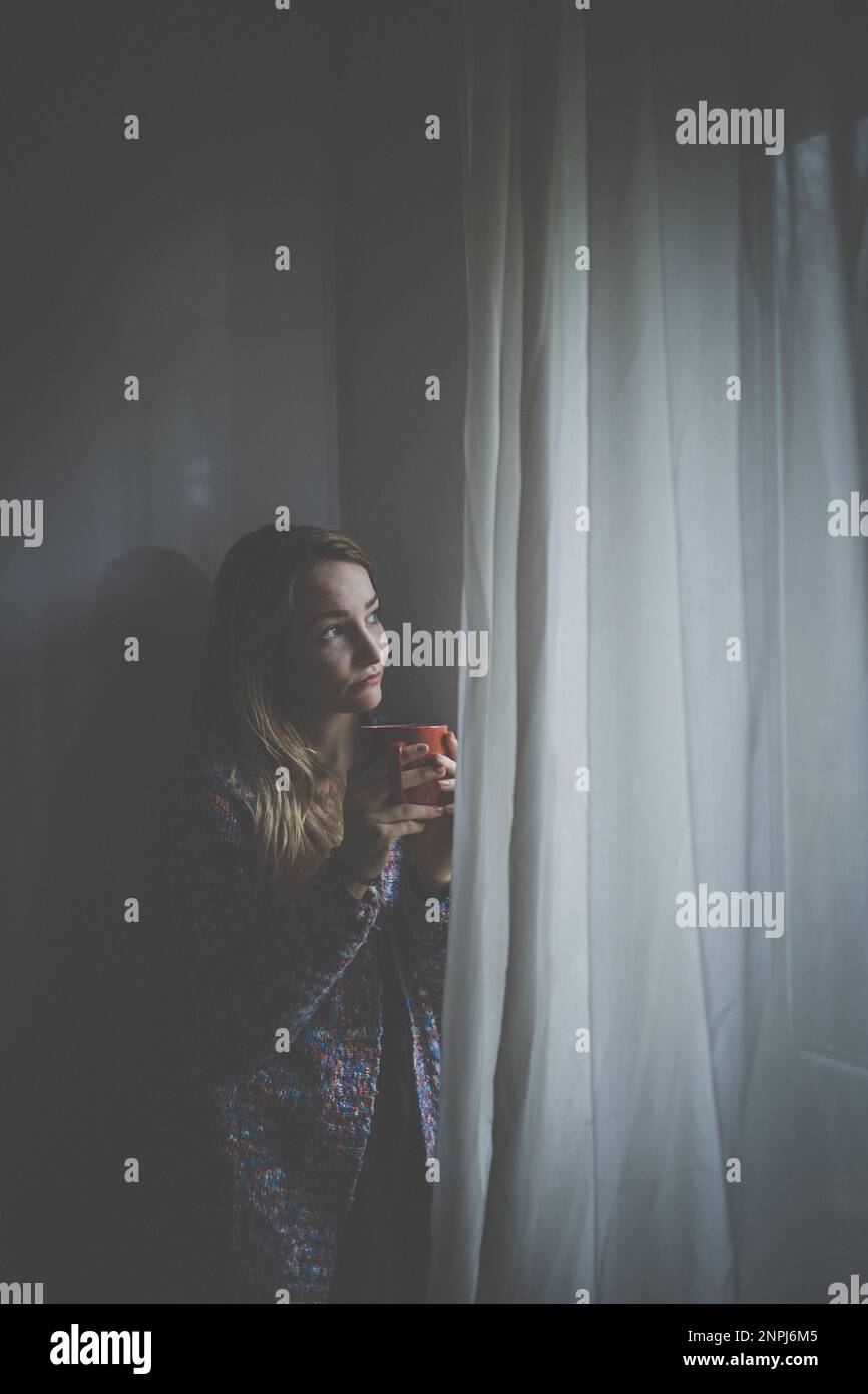 Cold, depressed, young woman at home feeling sad, lonely, anxious ...
