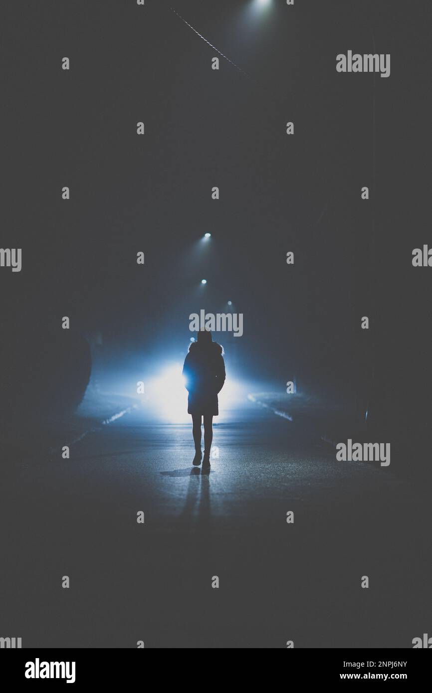 Woman Standing Alone In The Dark