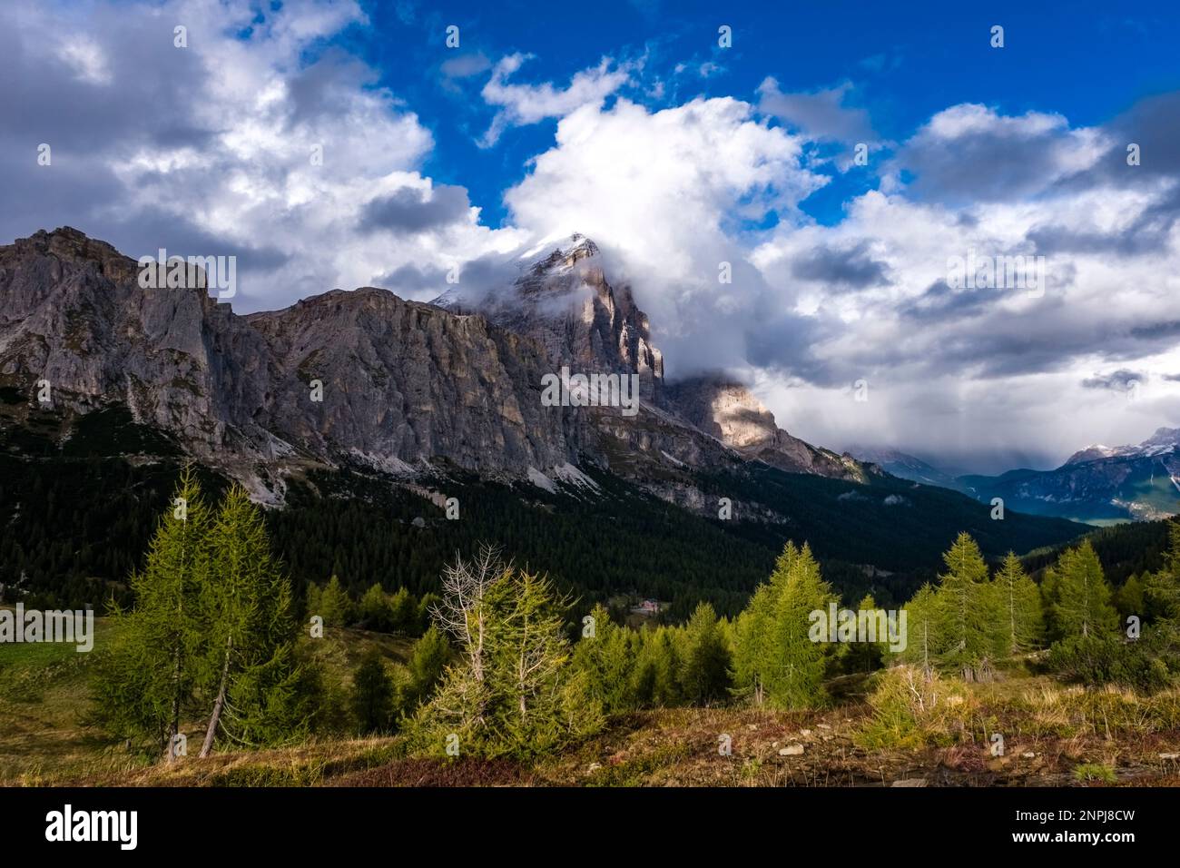 The snow covered summit of the rock formation Tofane, partially ...