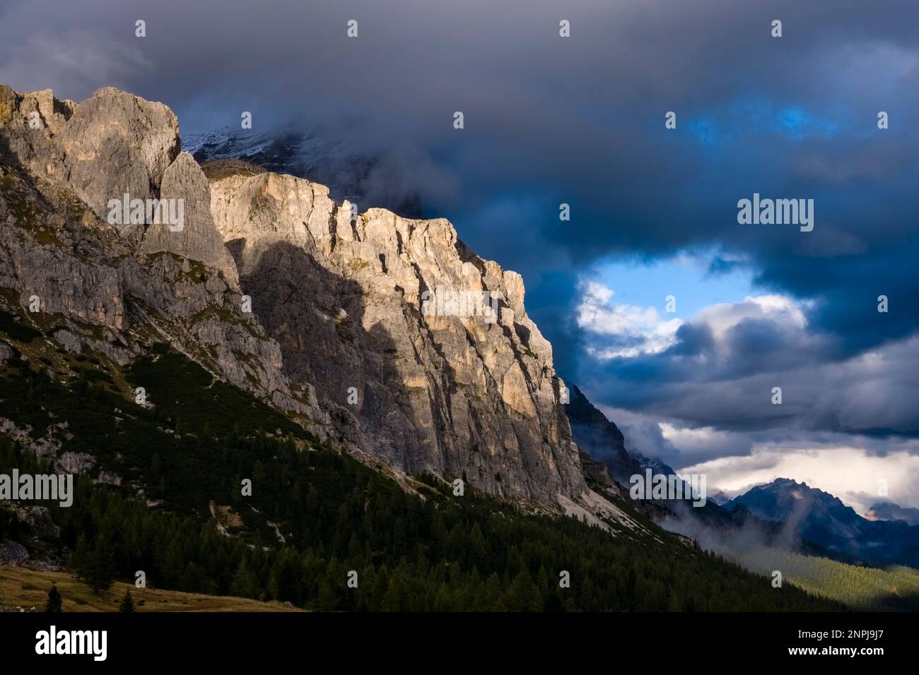 Cliffs of the rock formation Tofane, the snow covered summit partially ...