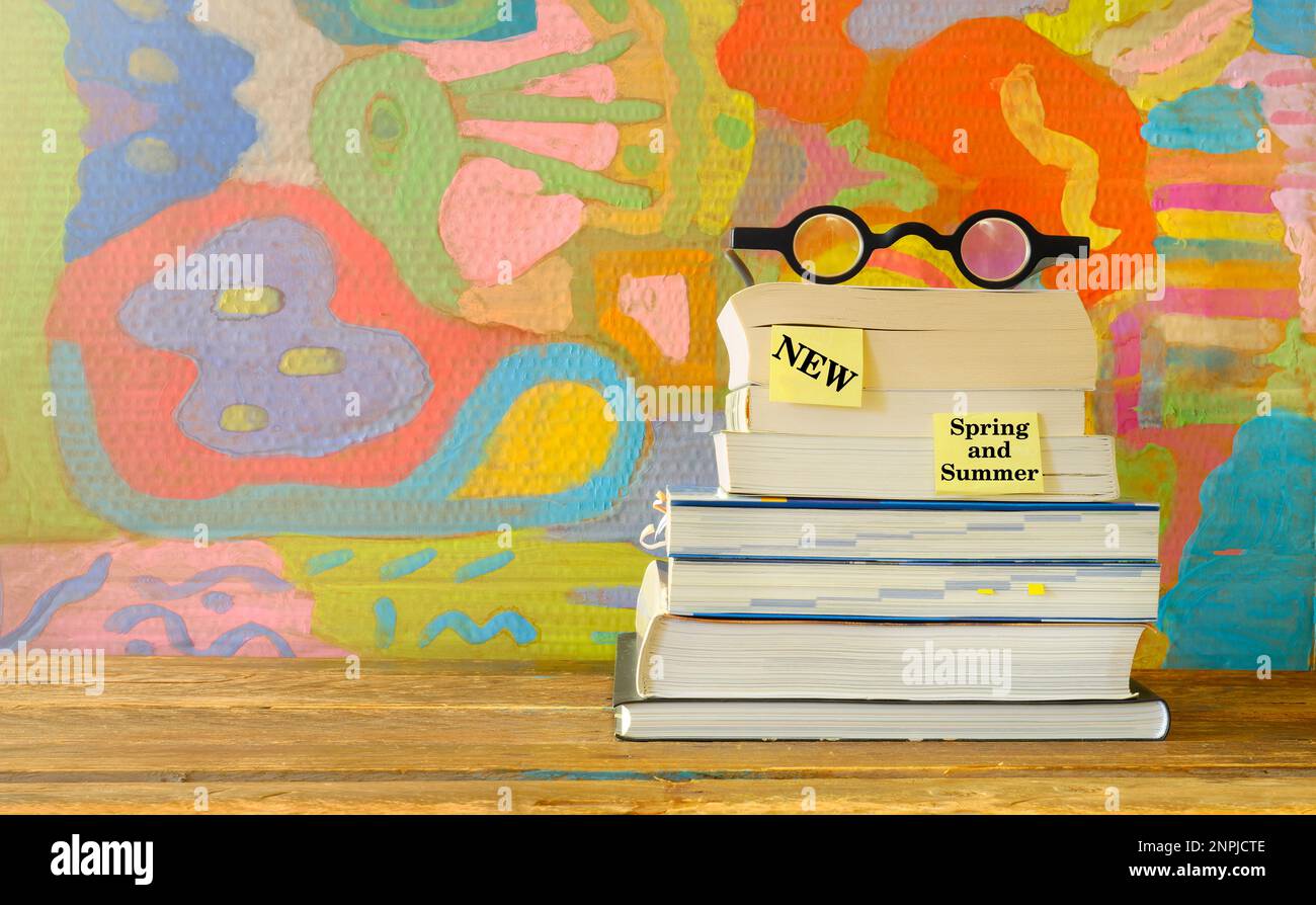 New book releases for spring 2023, with stack of books, spectacles and ...