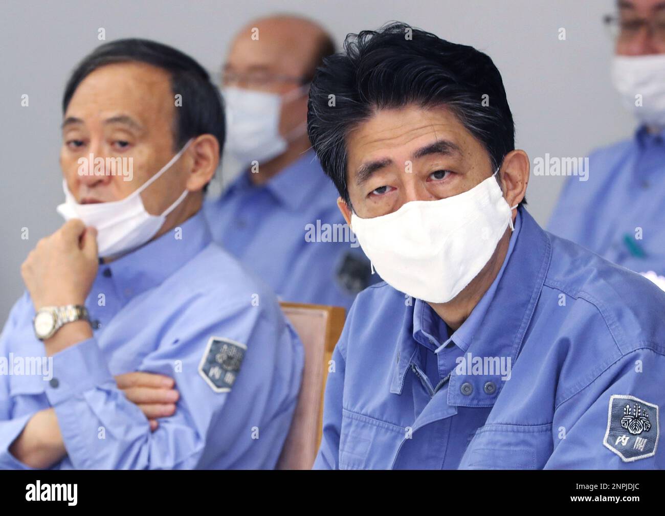 Japan's Prime Minister Shinzo Abe (R) wearing face mask attends a ...