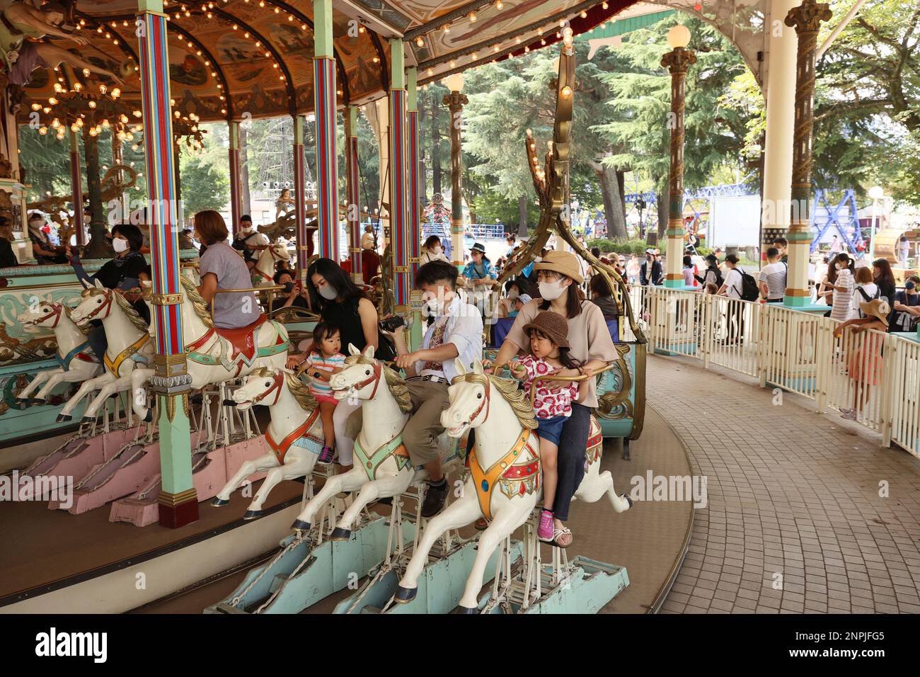 Visitors enjoy riding Carousel El Dorado at Toshimaen amusement park, in Nerima Ward, Tokyo on ...