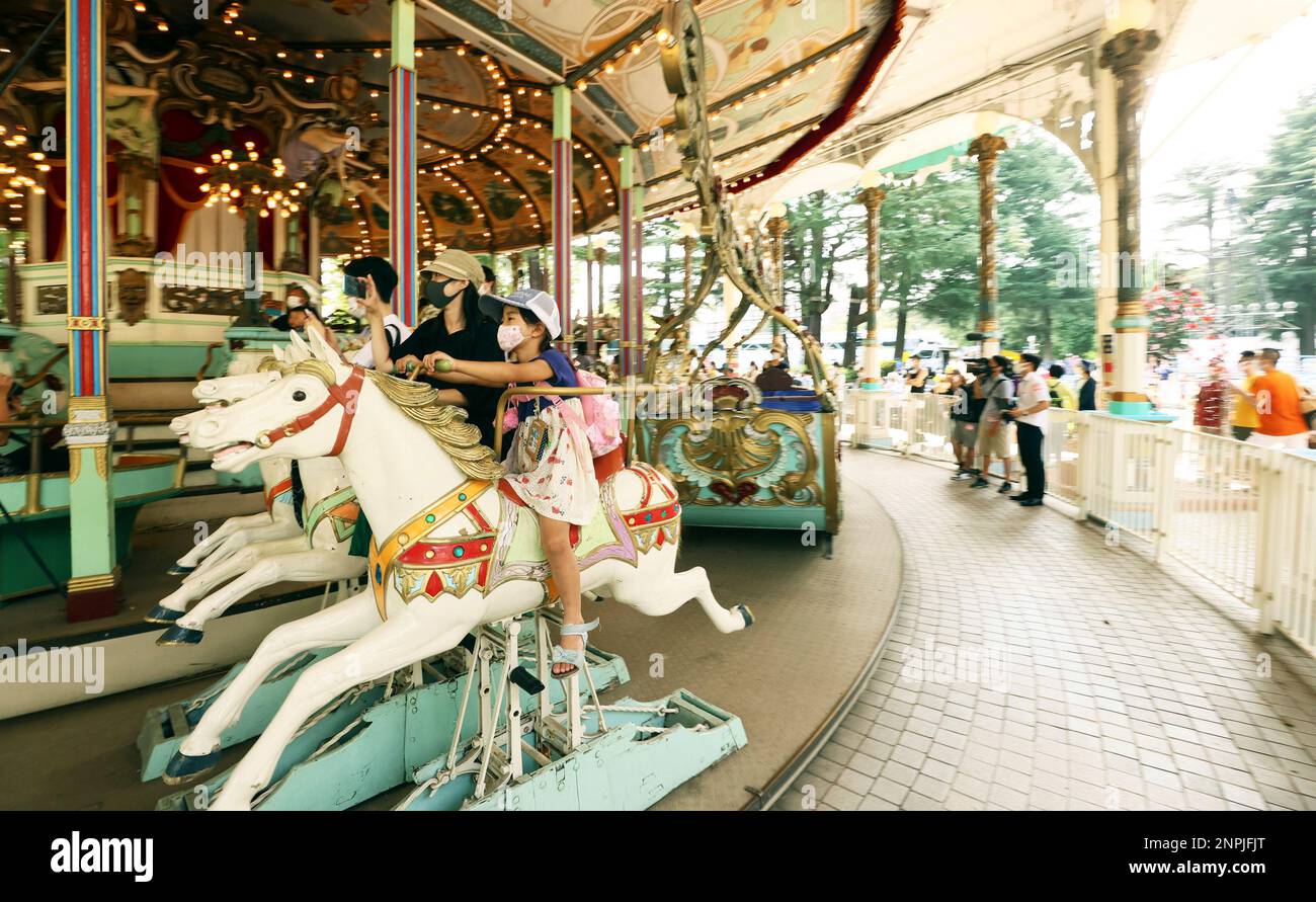 Visitors enjoy riding Carousel El Dorado at Toshimaen amusement park, in Nerima Ward, Tokyo on ...