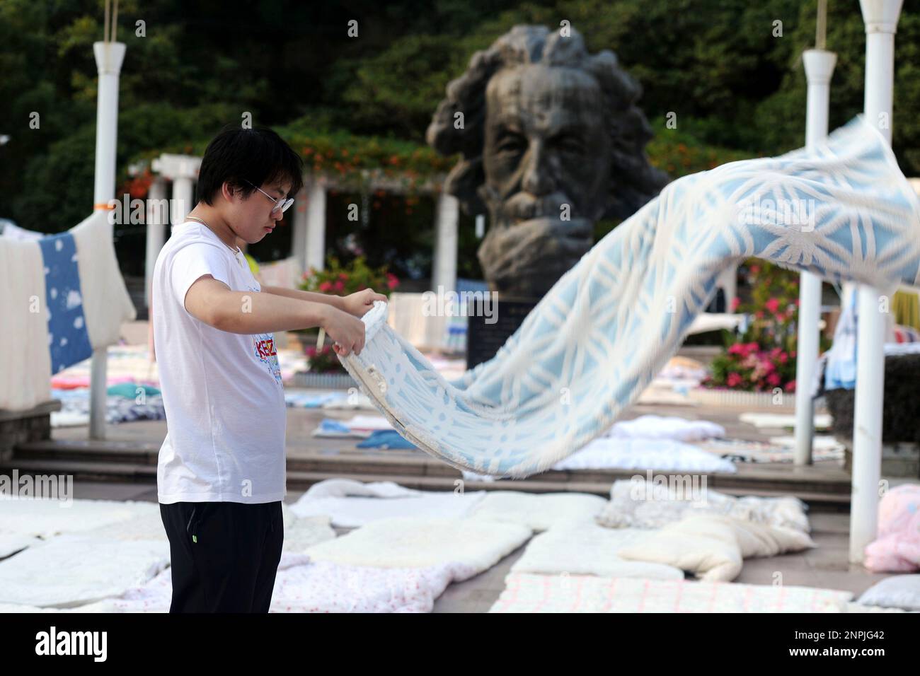 A student folds his quilt which has been aired on Einstein Square on ...