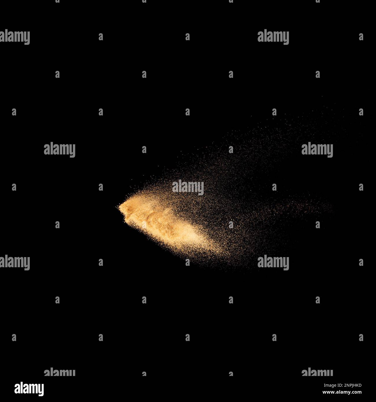 Golden sand explosion isolated on black background. Colored sand splash ...