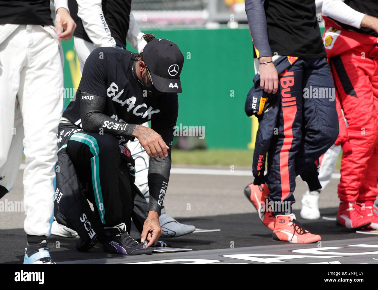 Mercedes driver Lewis Hamilton of Britain kneels in support of the ...