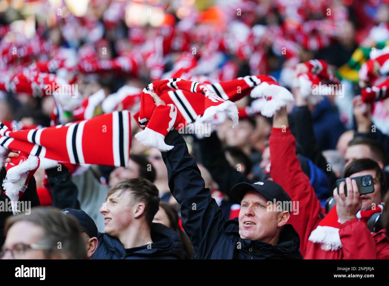 Manchester united fans wave flags hi-res stock photography and images ...