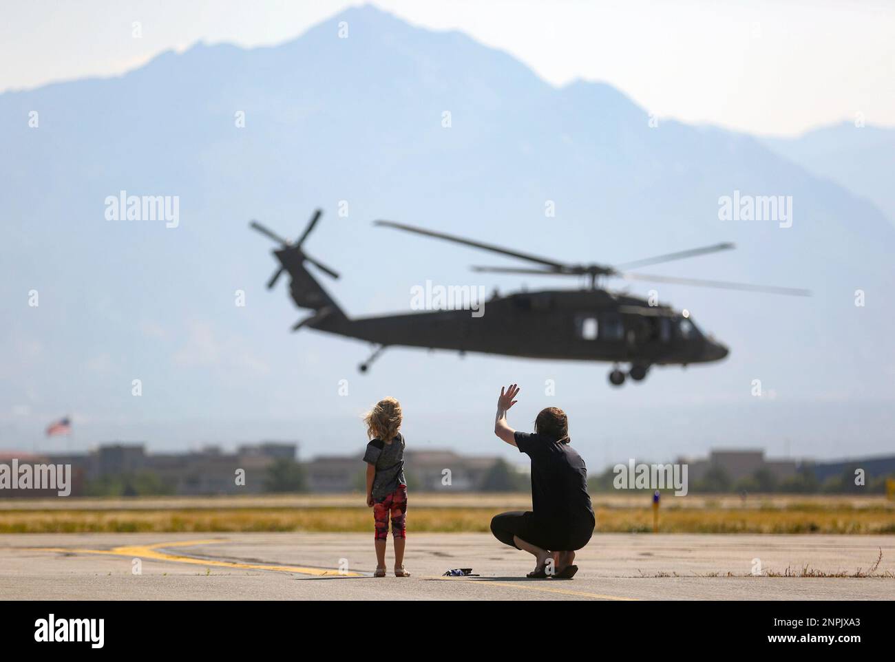 Ellie Hansen, 4, and Stephanie Hansen wave as Ellie's father and ...