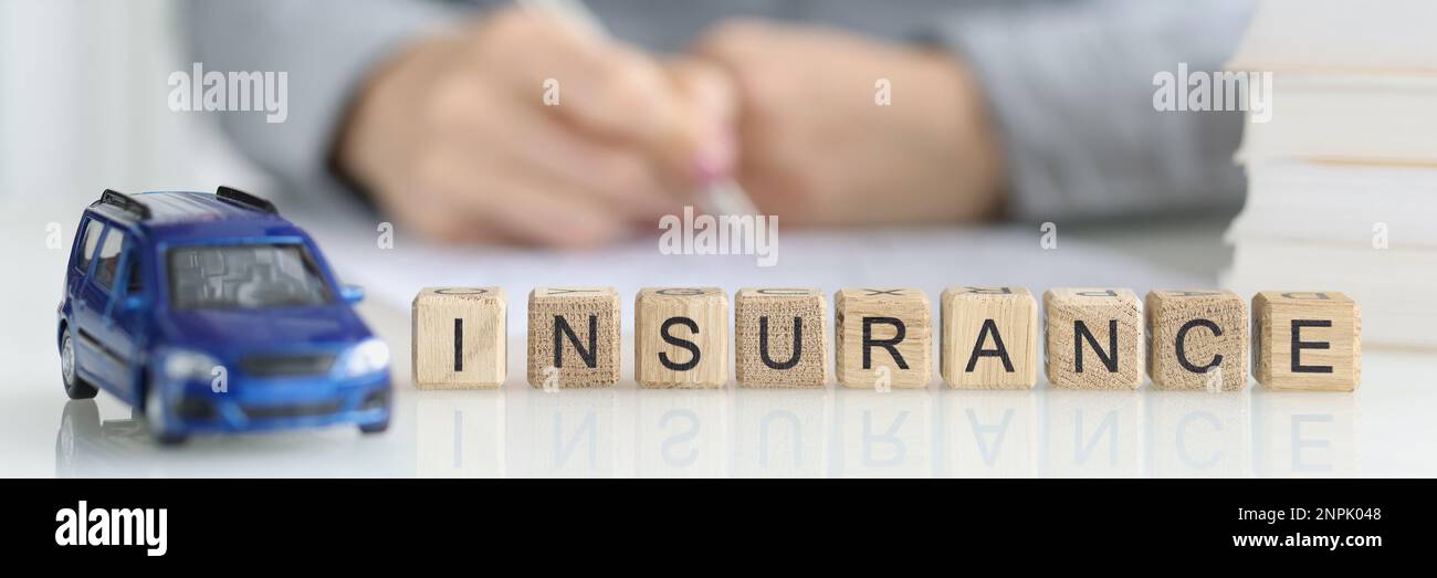 Sales representative fills out contractual documents for car insurance ...