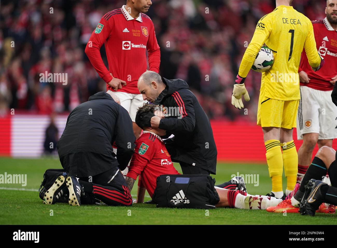 Manchester United's Lisandro Martinez receives medical attention during ...