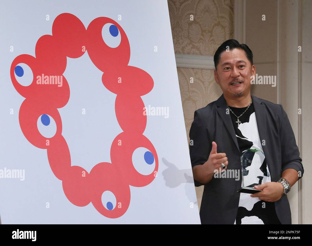 A graphic designer Tamotsu Shimada of TEAM IARI poses for photo after ...