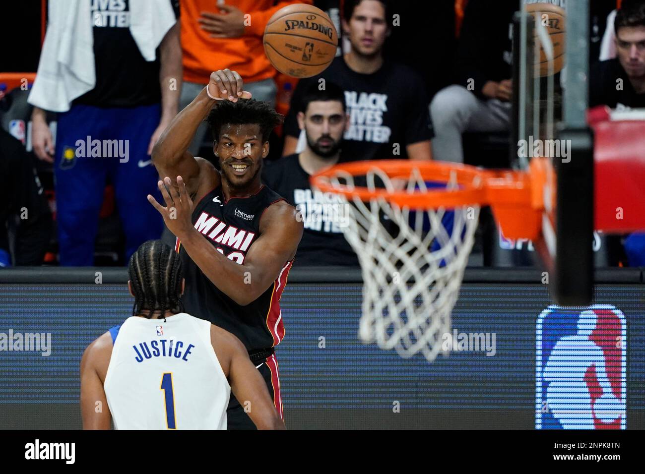 Miami Heat's Jimmy Butler (22) passes around Indiana Pacers' T.J ...