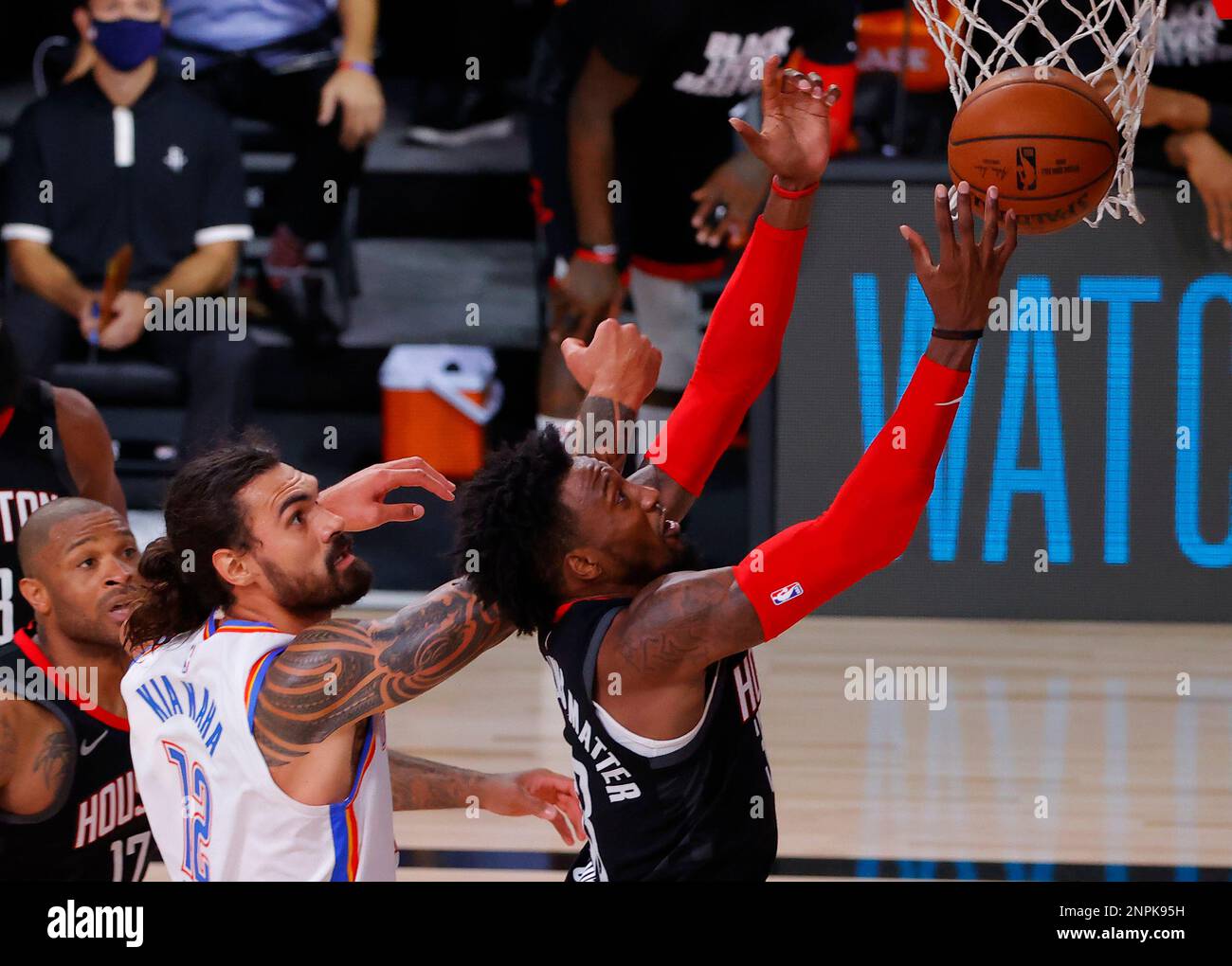 Houston Rockets' Robert Covington, right, grabs a rebound against ...