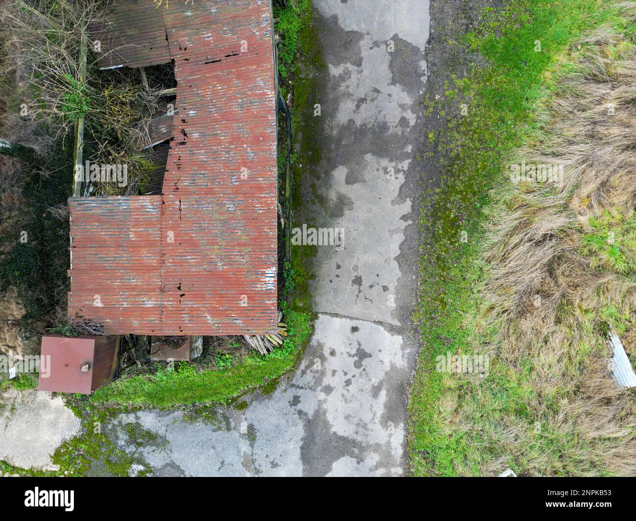 Top down view of derelict buildings seen on a farm. A diesel tank is on ...