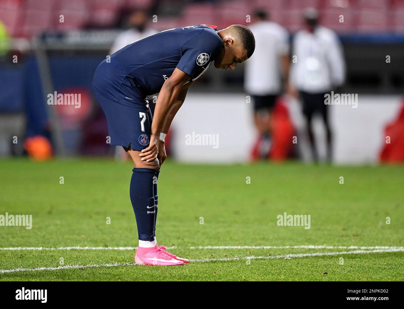 PSG's Kylian Mbappe stands on the pitch disappointed after losing the ...