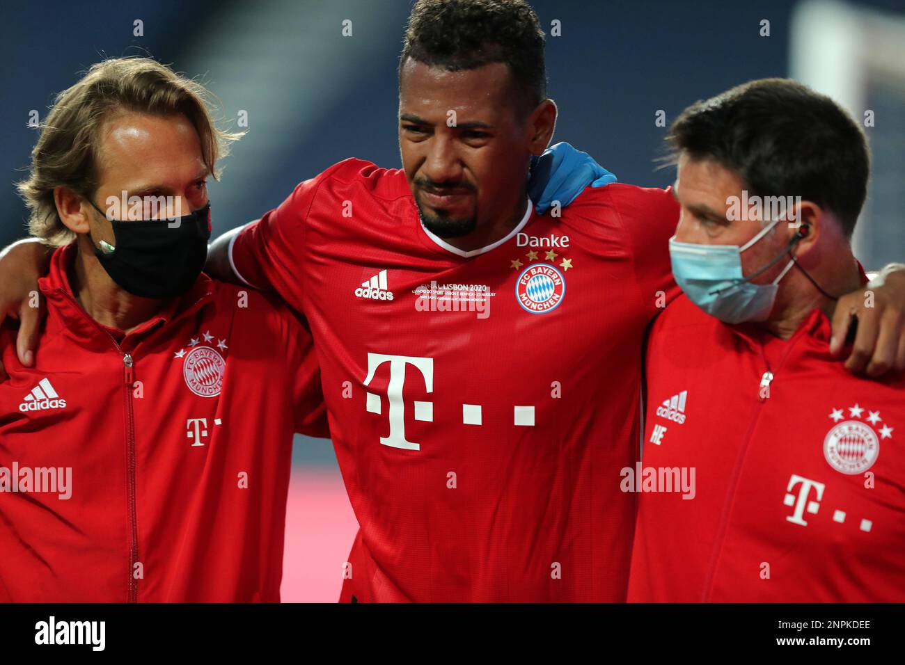 Bayern's Jerome Boateng is helped off the pitch after suffering an ...