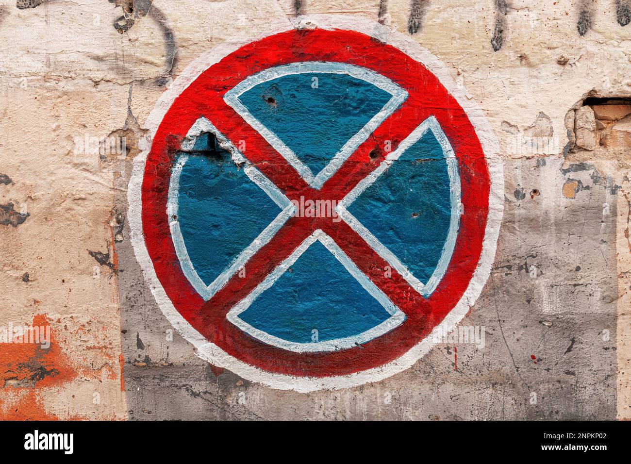 No stopping and no parking sign on old worn wall, hand painted traffic ...